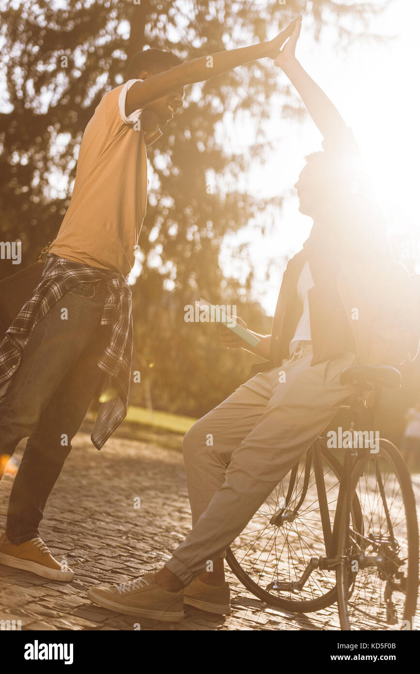 students making high five Stock Photo - Alamy