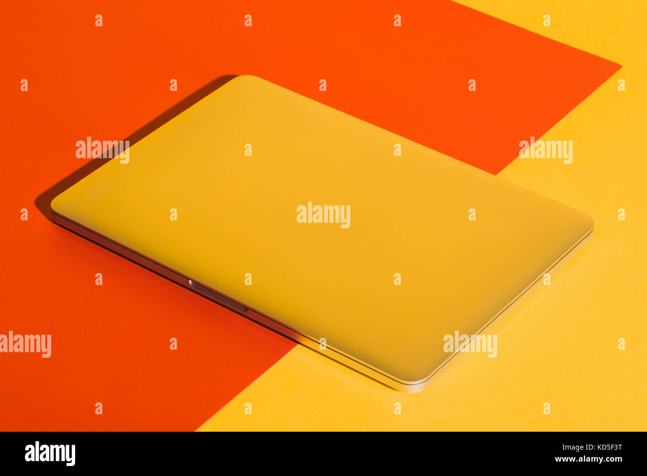 laptop on yellow and red Stock Photo - Alamy