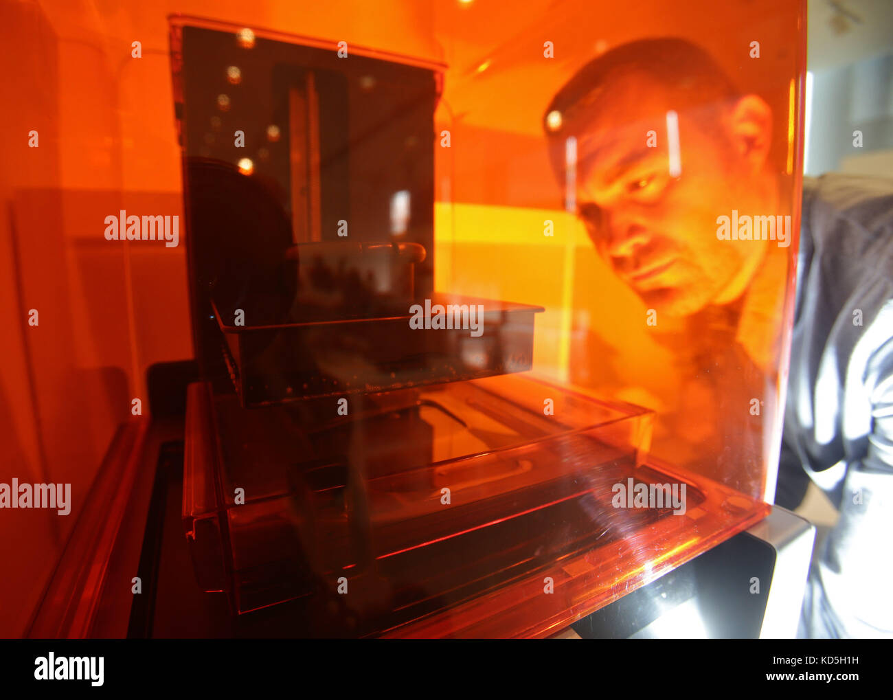 Sculptor Zachary Eastwood-Bloom next to a 3D printer used to create his ...