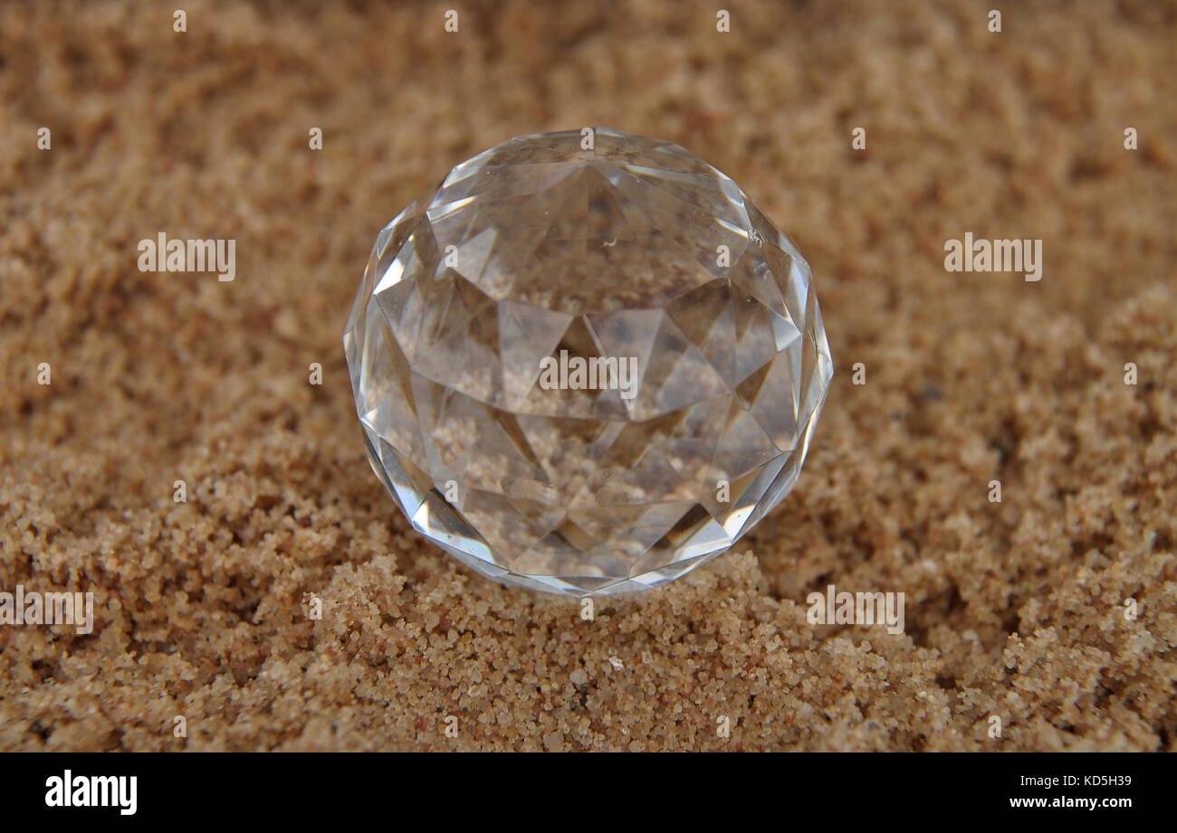 Crystal ball on sand Stock Photo - Alamy