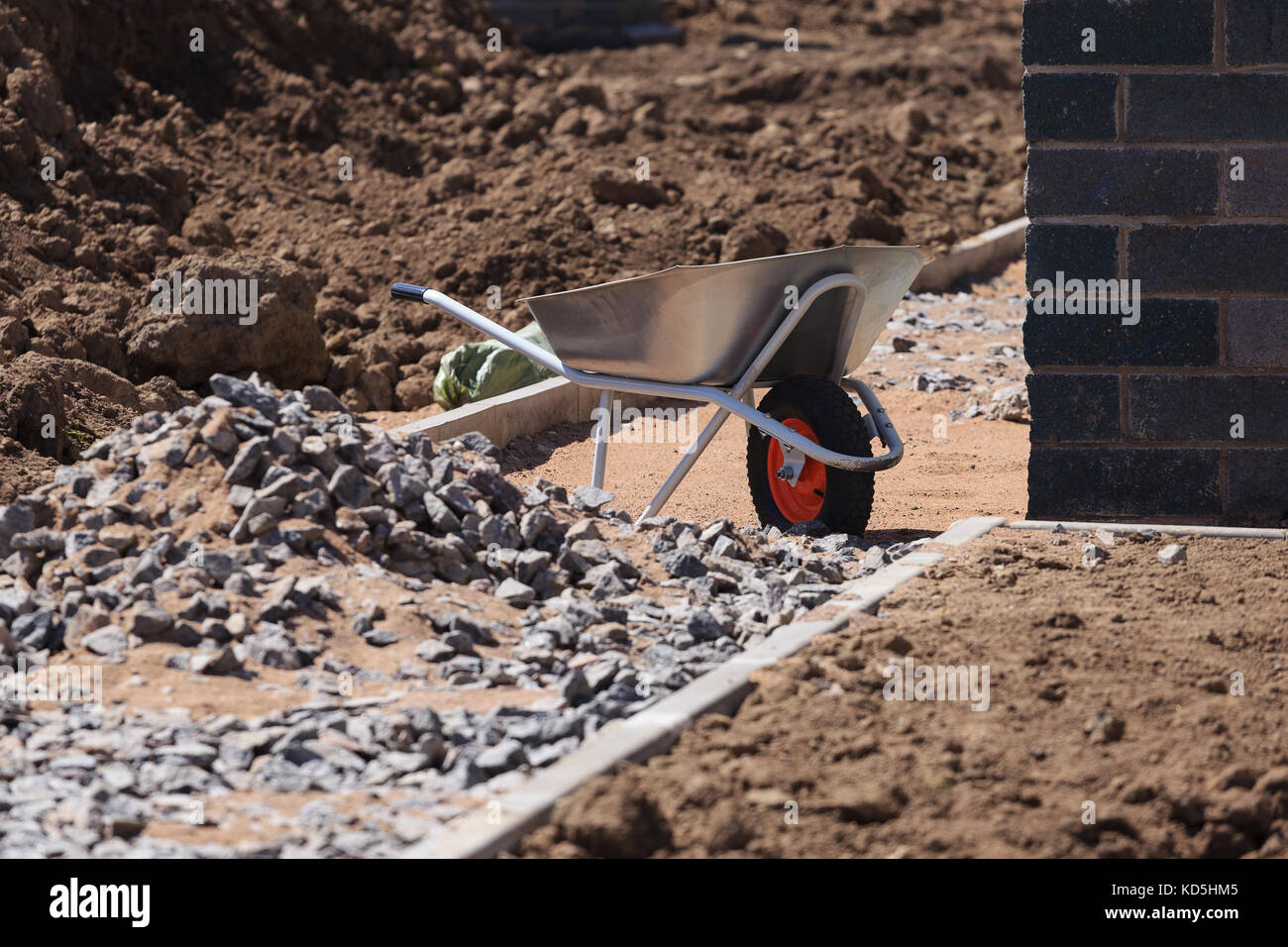Professional galvanized wheelbarrow on the background of construction ...