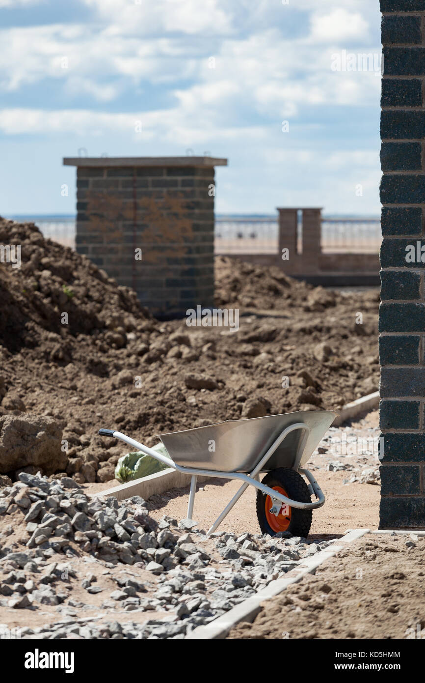 Professional galvanized wheelbarrow on the background of construction ...