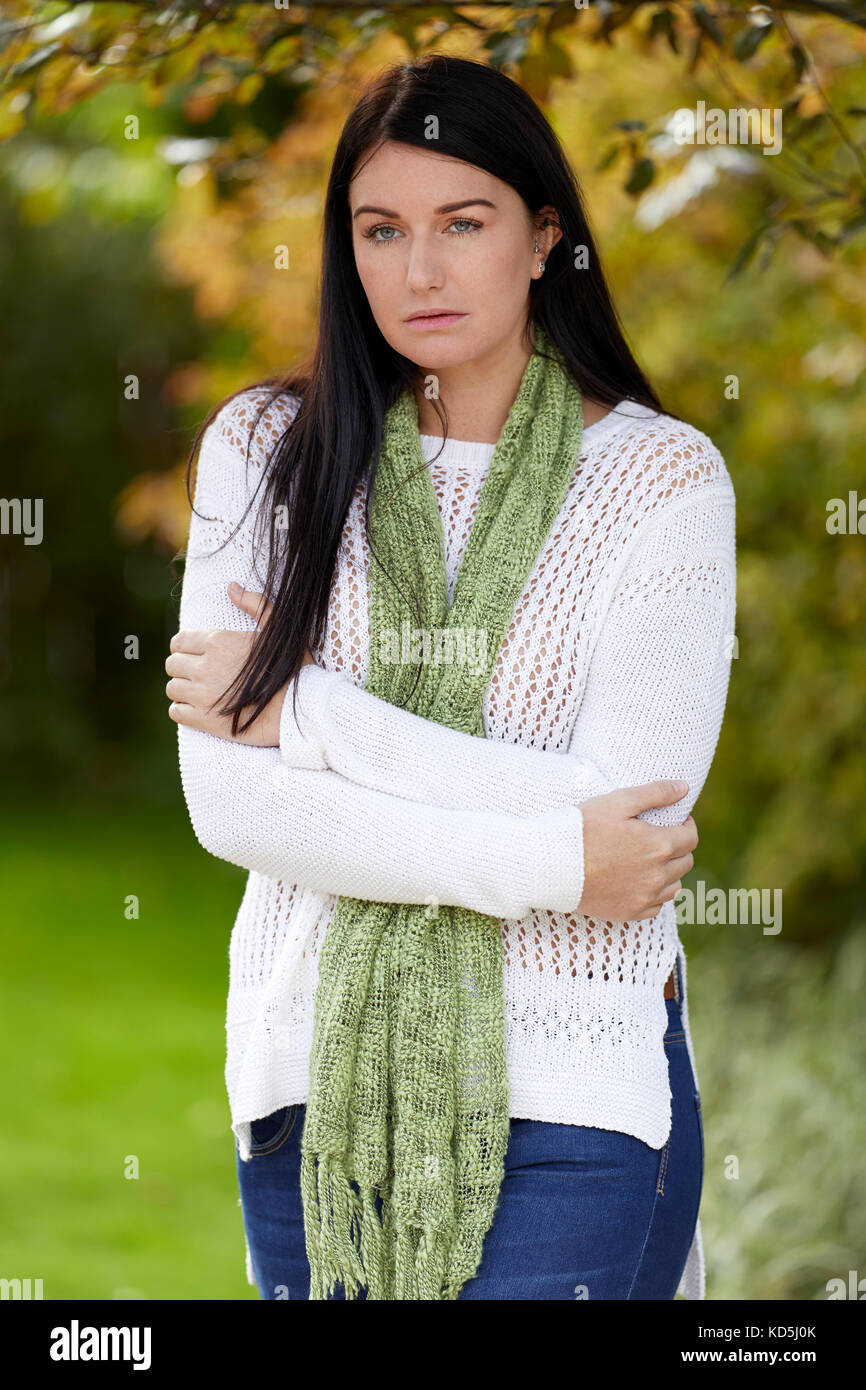 Woman looking concerned outdoors Stock Photo - Alamy