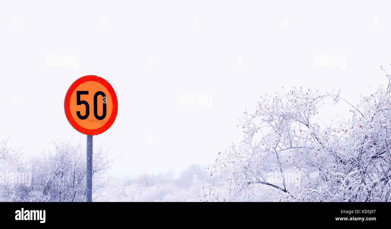 Speed limit traffic sign in winter Stock Photo - Alamy