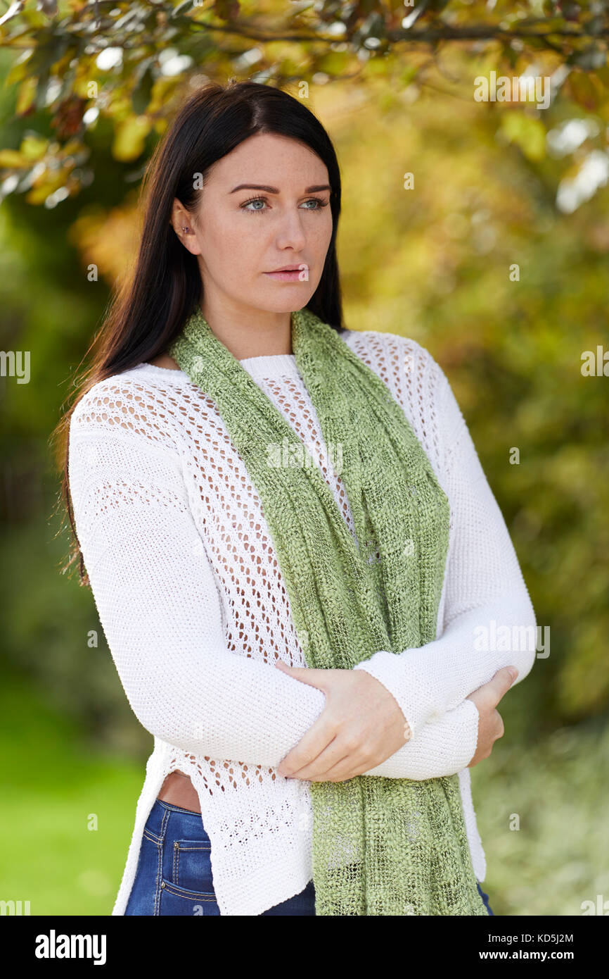 Woman looking concerned outdoors Stock Photo - Alamy