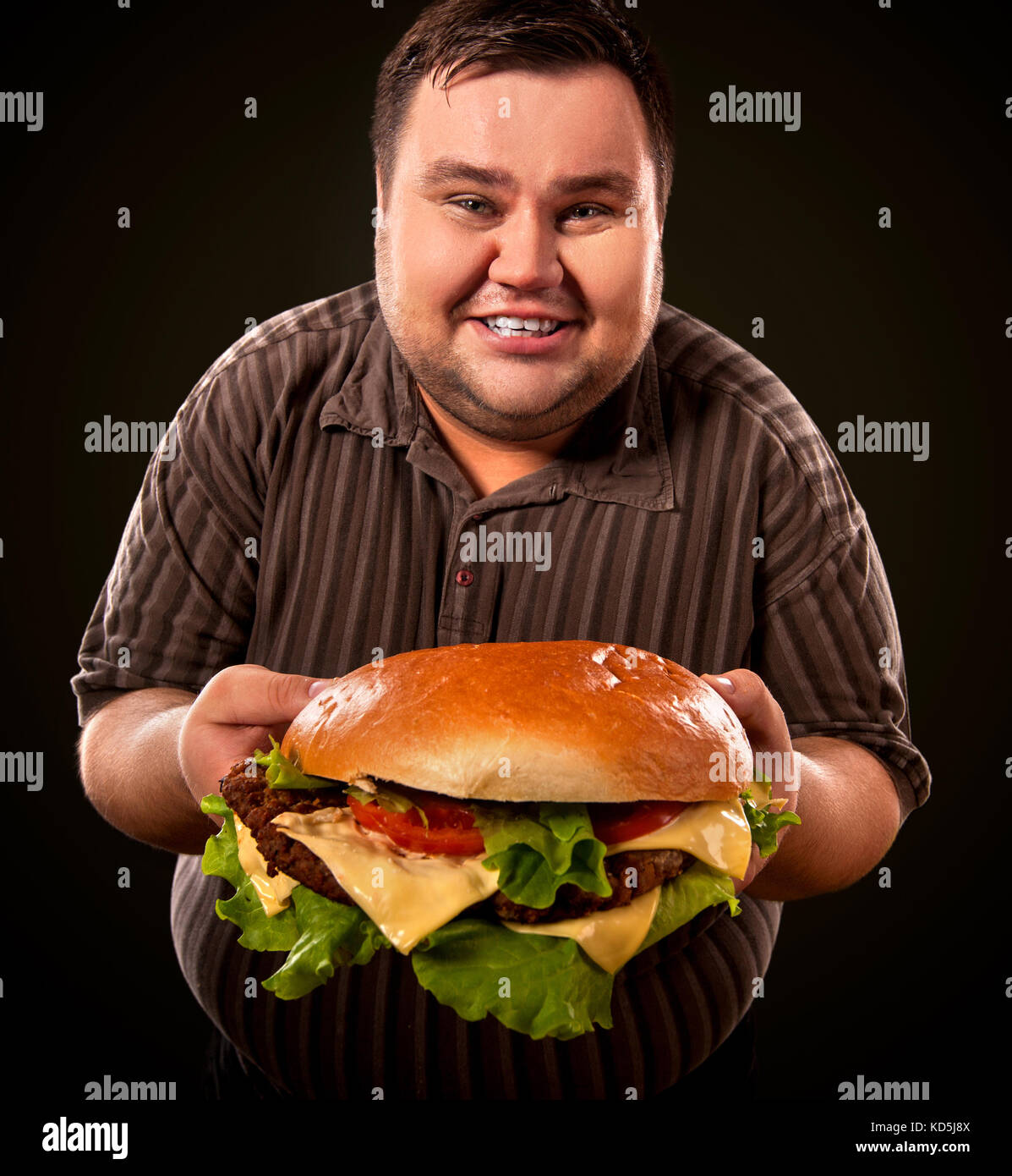 Fat man eating fast food hamberger. Breakfast for overweight person ...