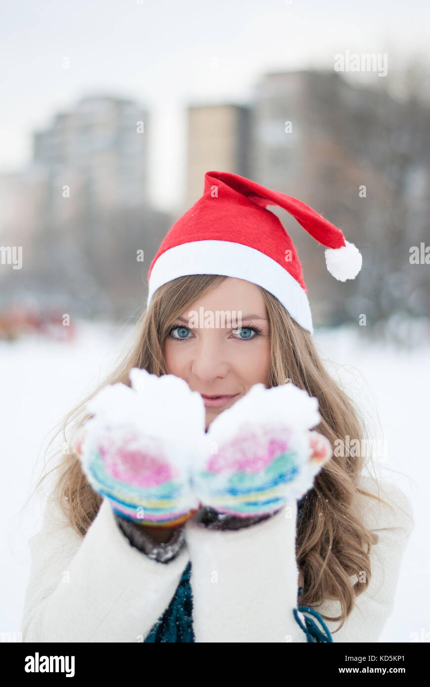 beautiful young girl posing in the snow with colorful gloves Stock ...