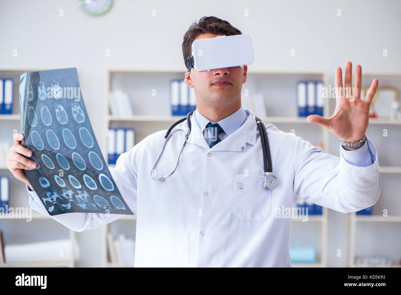 Young doctor looking at MRI scan through VR glasses Stock Photo - Alamy