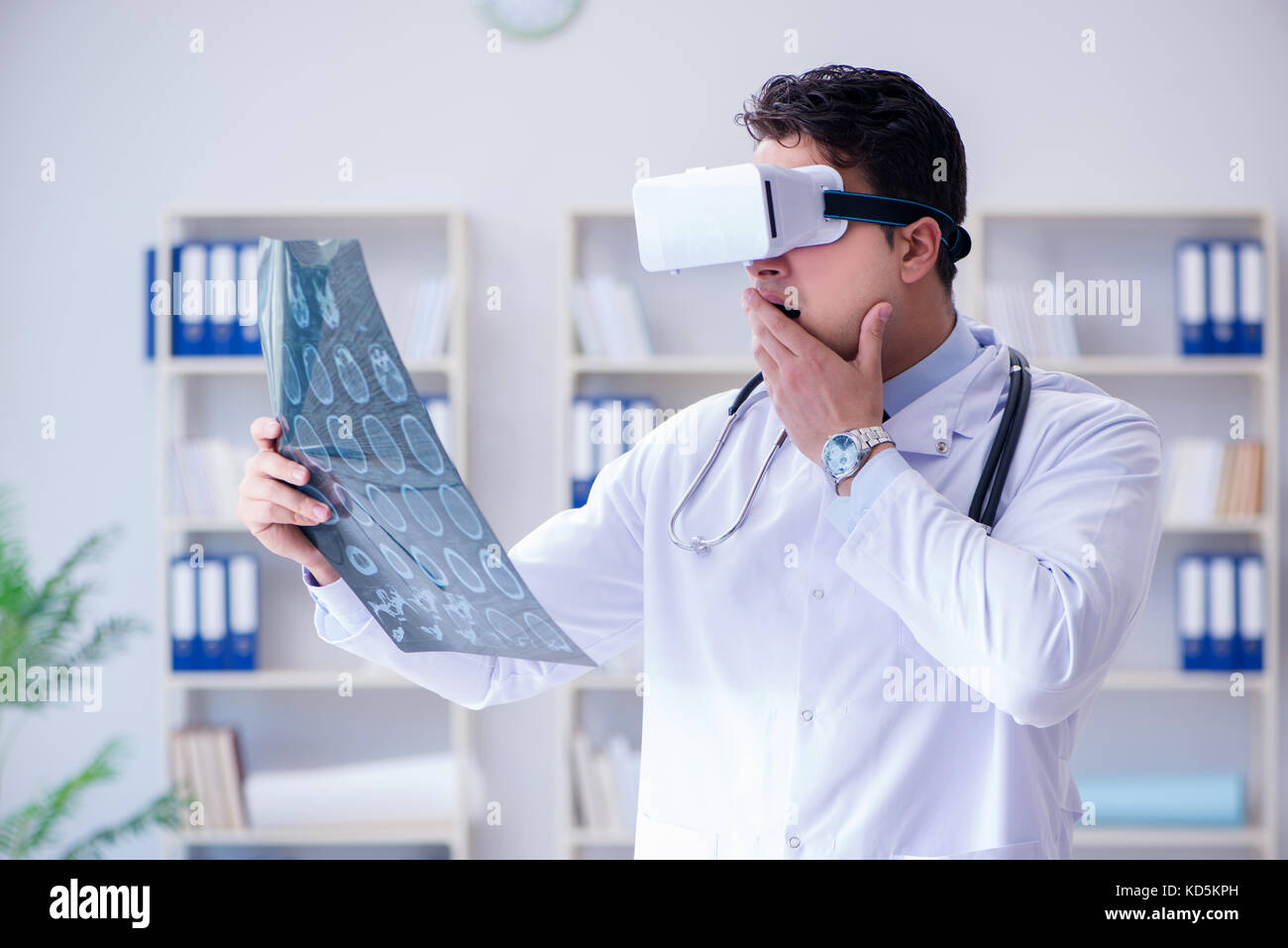 Young doctor looking at MRI scan through VR glasses Stock Photo - Alamy