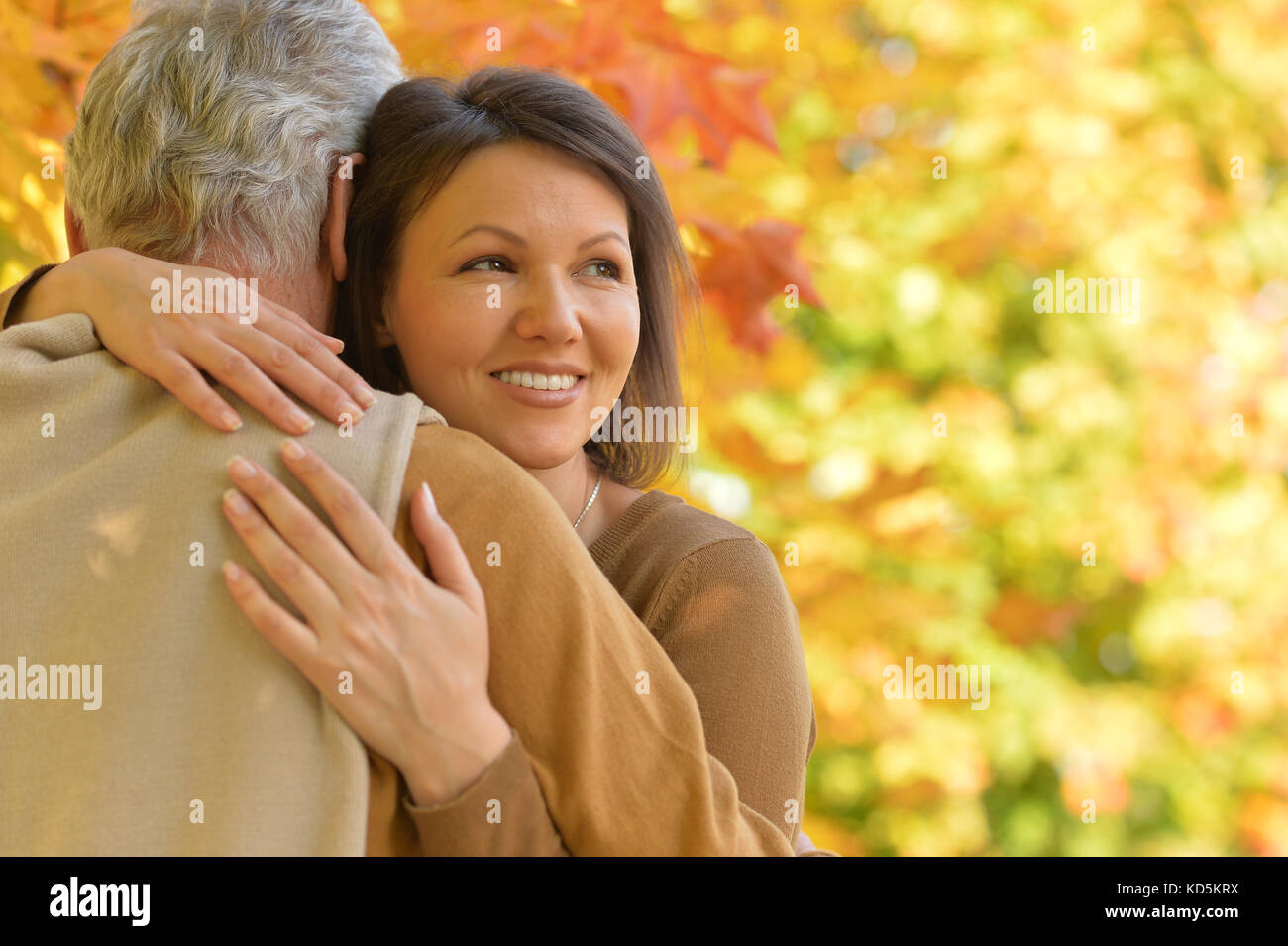 Mature woman hugging father Stock Photo - Alamy