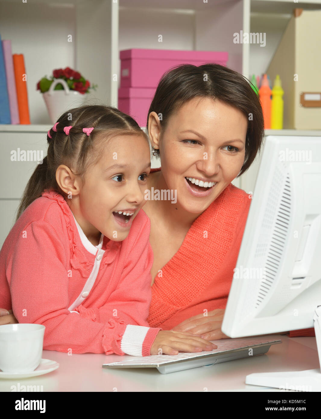 woman and little girl using computer Stock Photo - Alamy