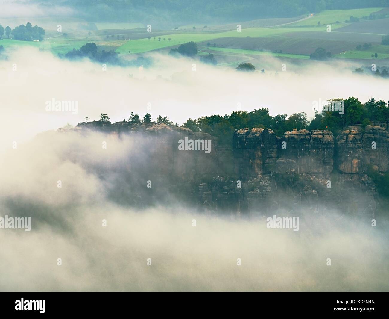 Autumn inversion fog. Peaks of hills increased from foggy background ...