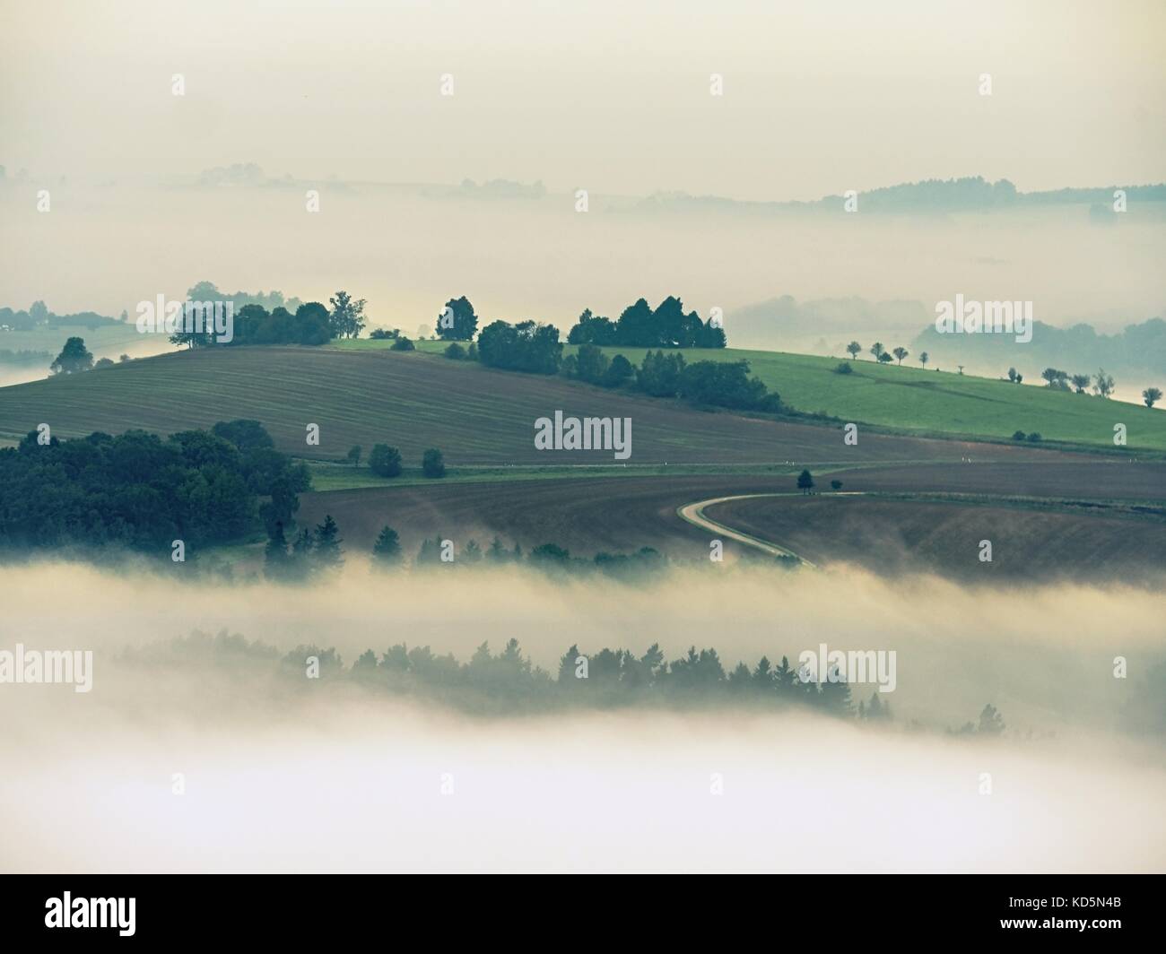 Autumn inversion fog. Peaks of hills increased from foggy background ...