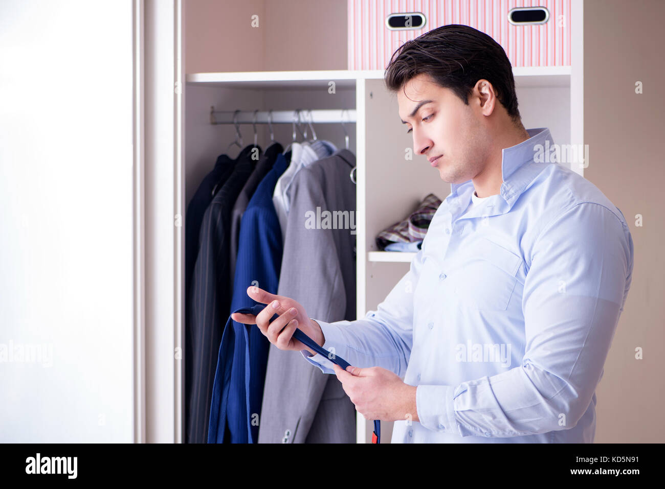 Young man businessman getting dressed for work Stock Photo - Alamy