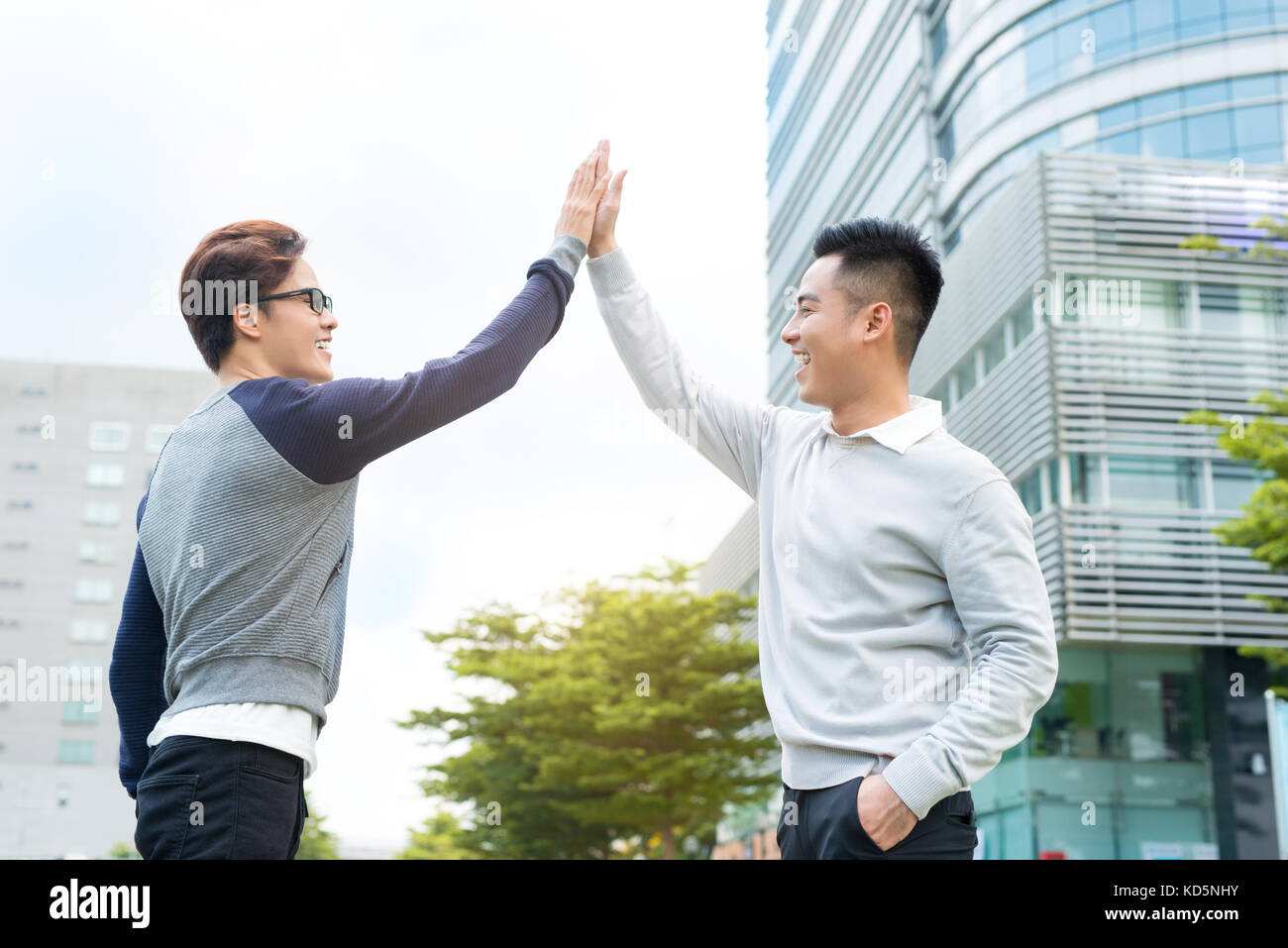 Two businessmen celebrate victory, goal reach, high five Stock Photo ...