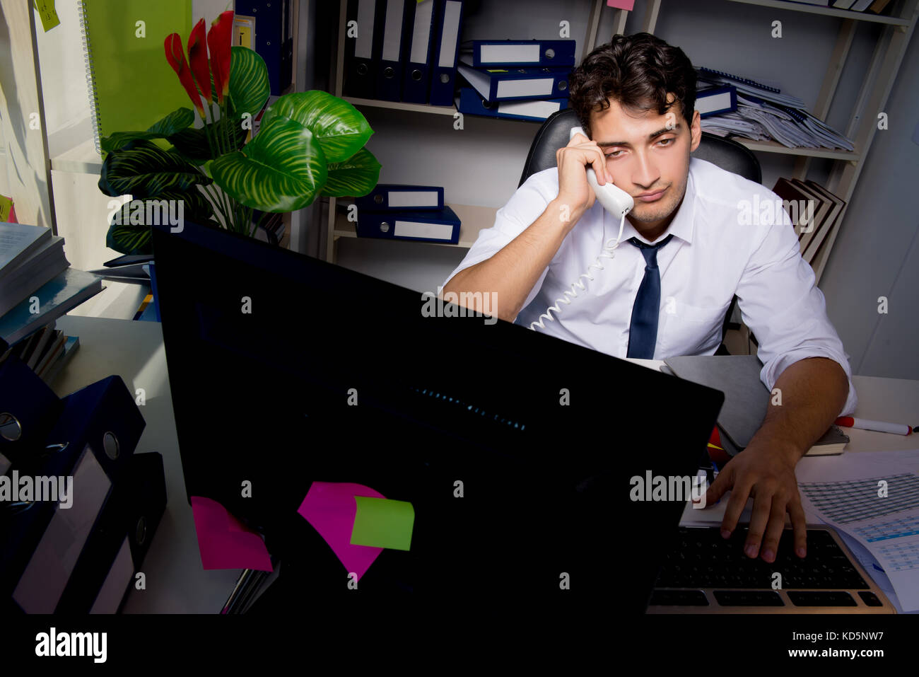 Man businessman working late hours in the office Stock Photo - Alamy
