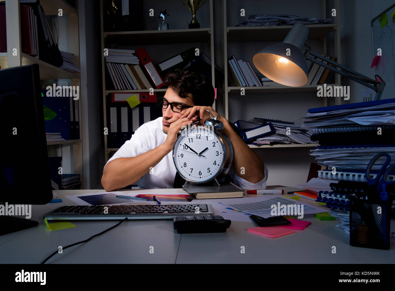 Man businessman working late hours in the office Stock Photo - Alamy
