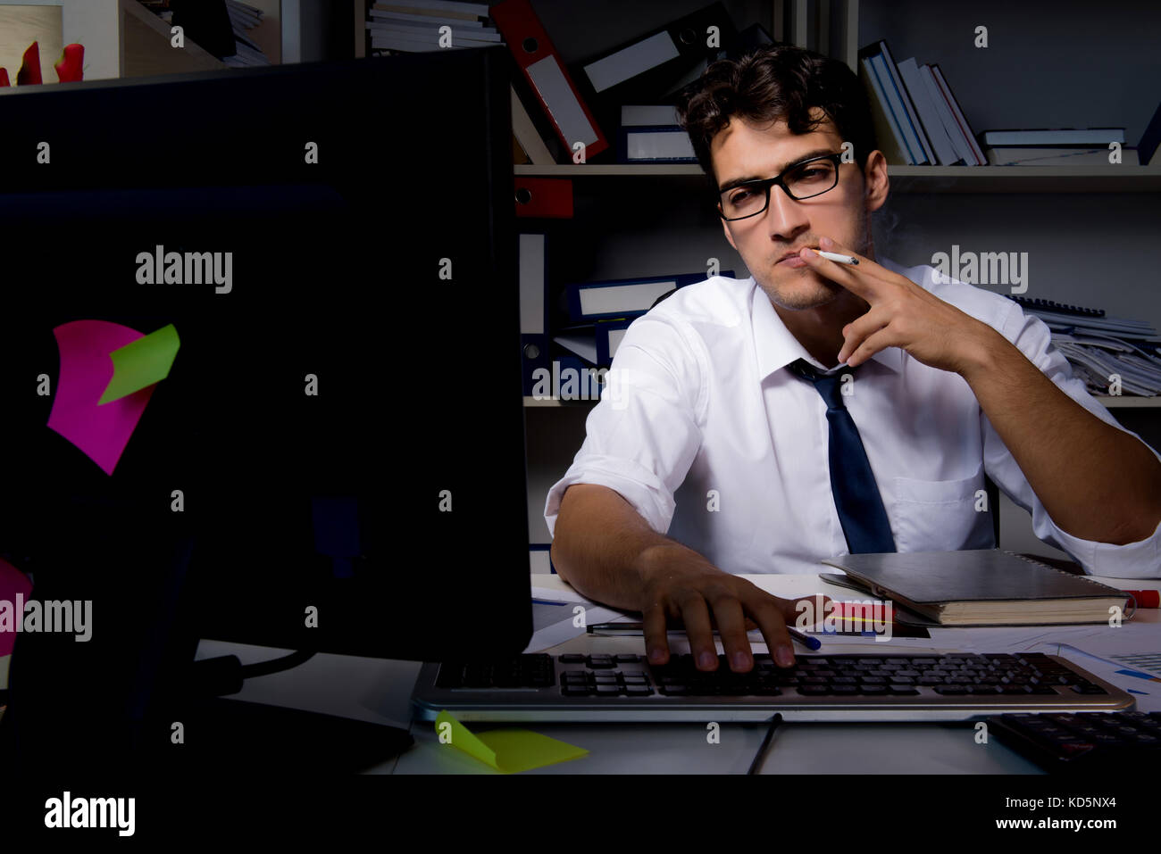Man businessman working late hours in the office Stock Photo - Alamy