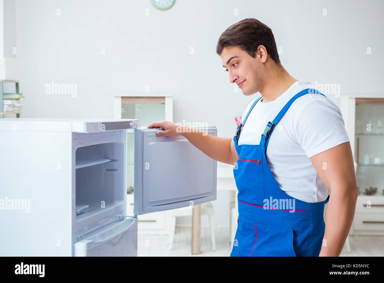 Repairman contractor repairing fridge in DIY concept Stock Photo - Alamy