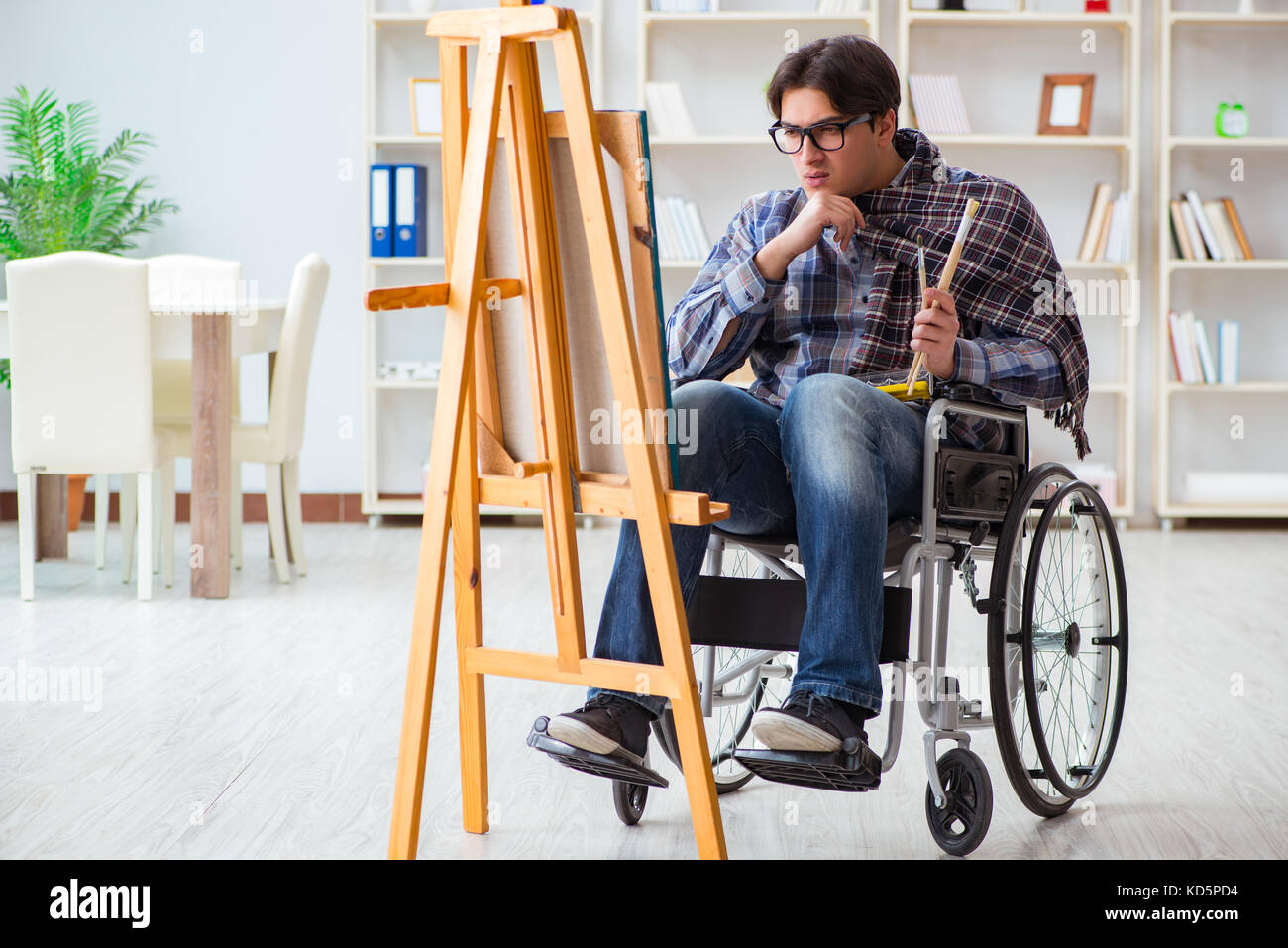 Disabled artist painting picture in studio Stock Photo - Alamy