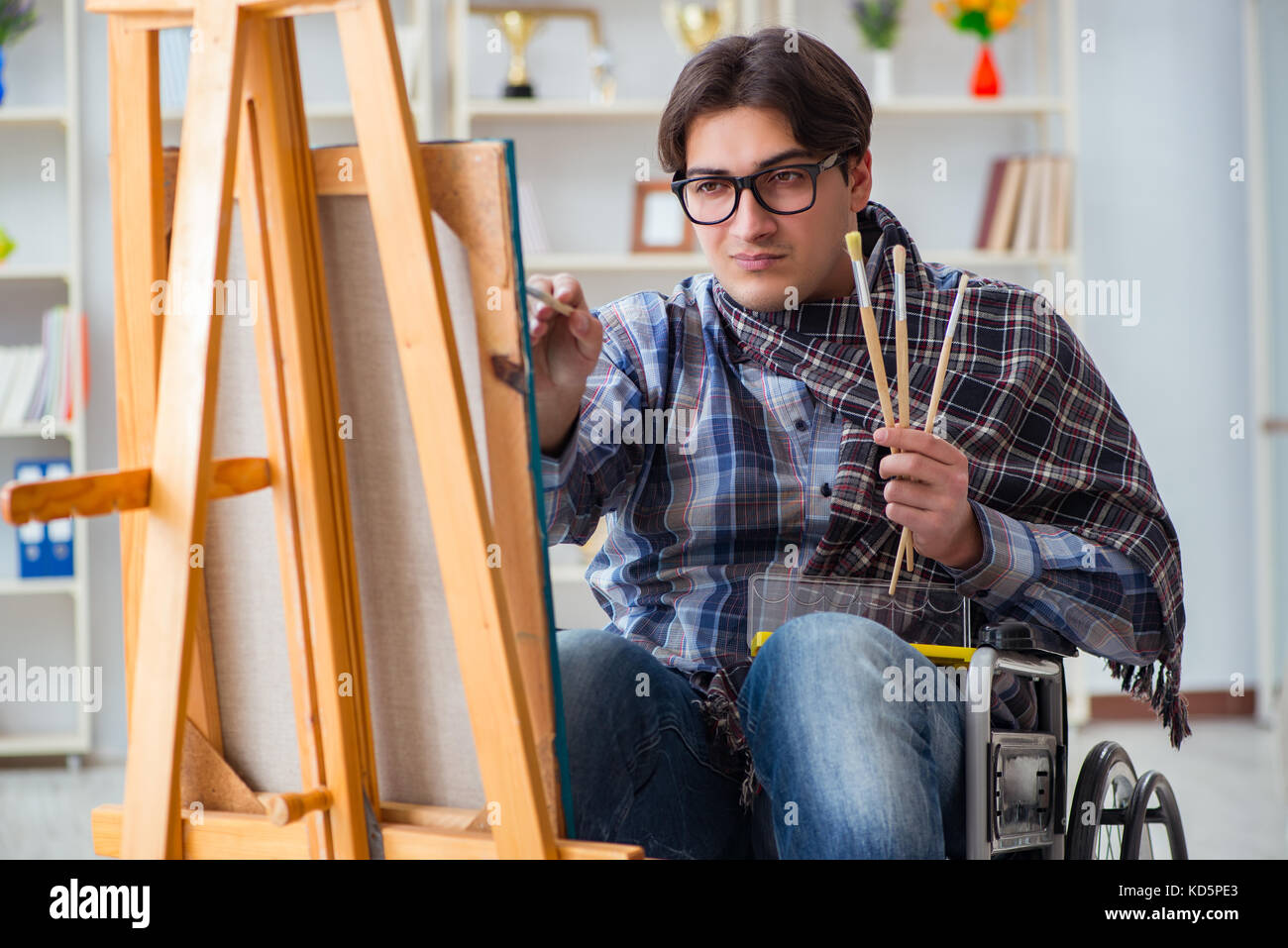 Disabled artist painting picture in studio Stock Photo - Alamy