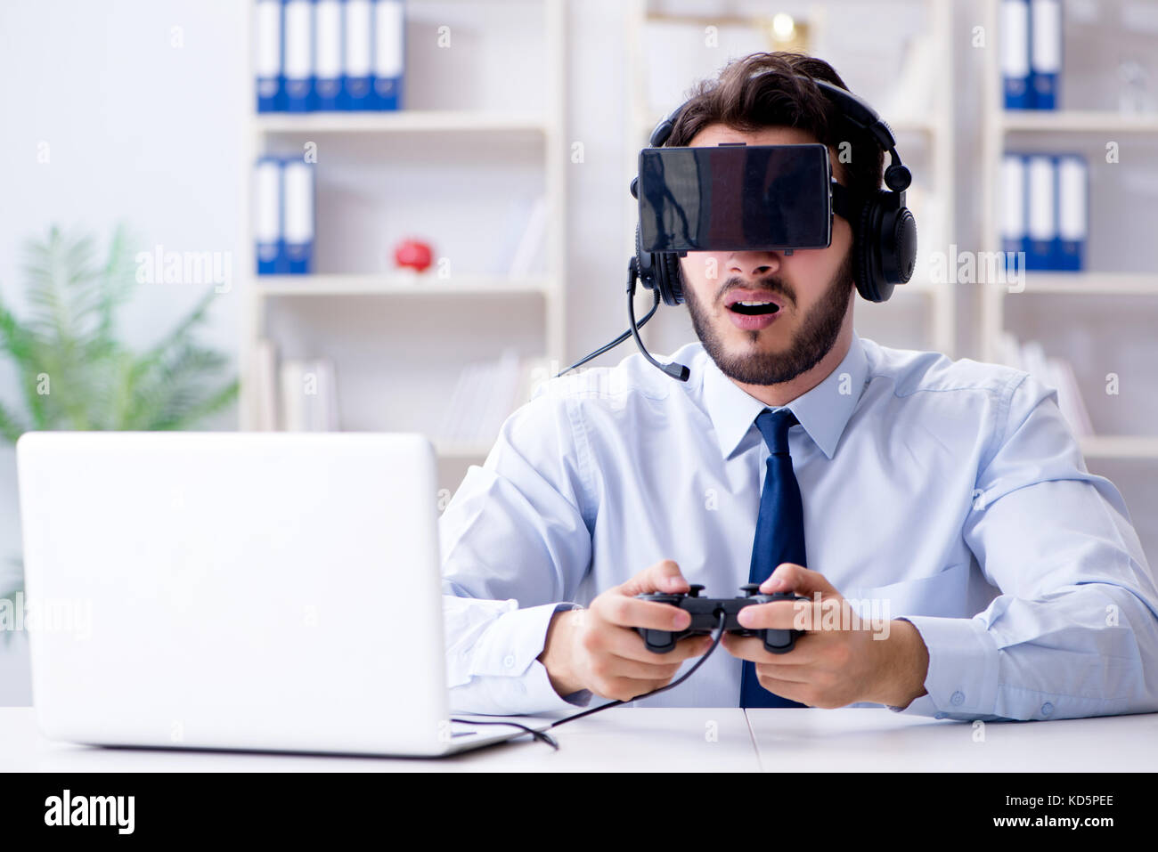 Businessman gamer in office playing games Stock Photo - Alamy
