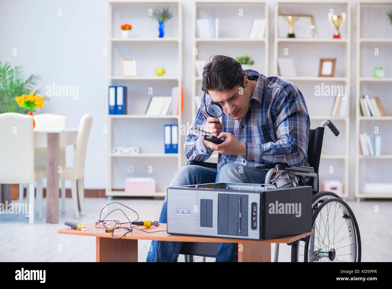 Computer repairman on wheelchair working Stock Photo - Alamy