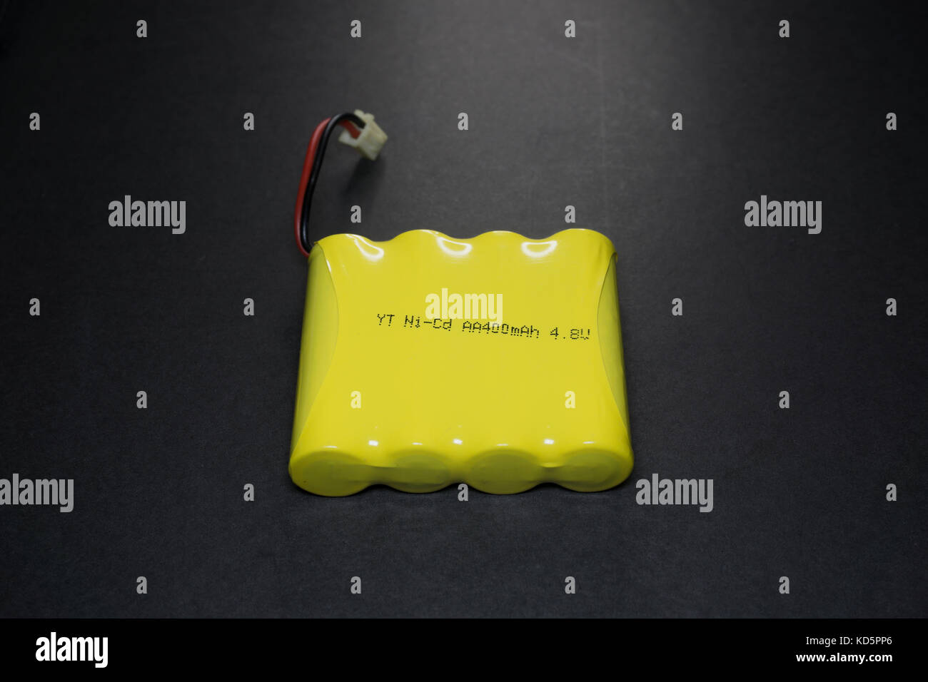 Yellow rechargeable battery pack isolated black Stock Photo - Alamy