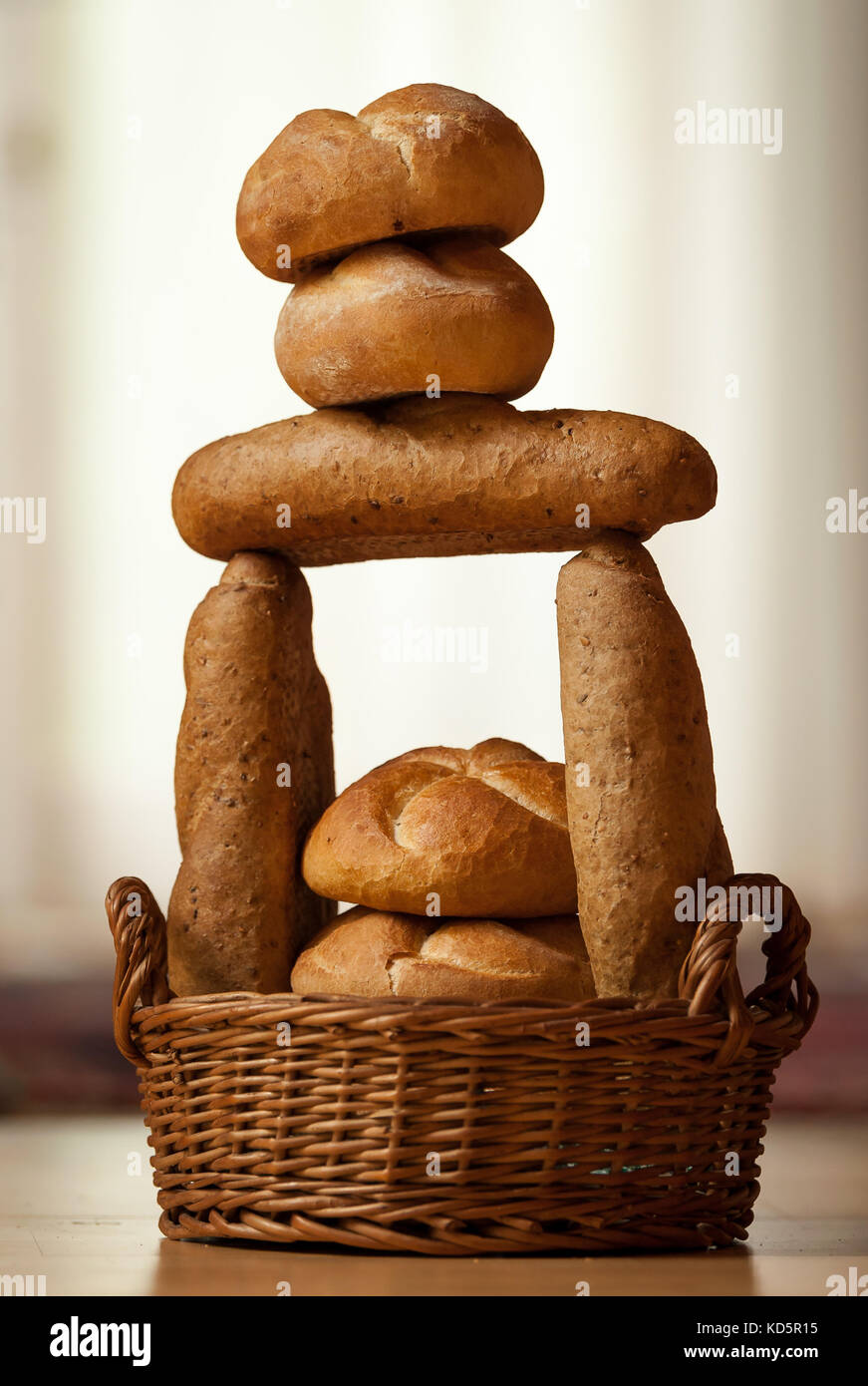 Various types of bread put together to form a tower Stock Photo - Alamy