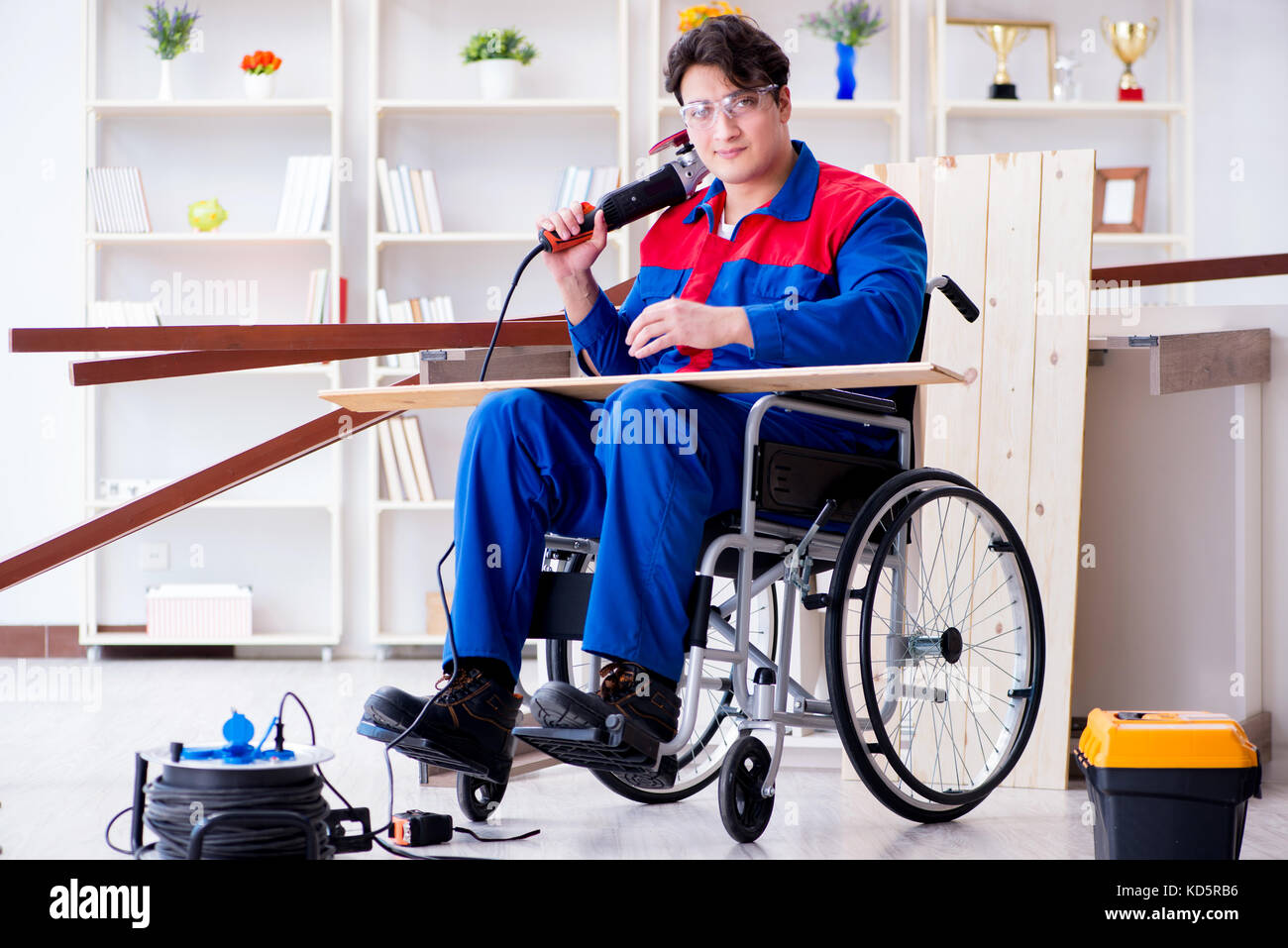Disabled carpenter working with tools in workshop Stock Photo - Alamy