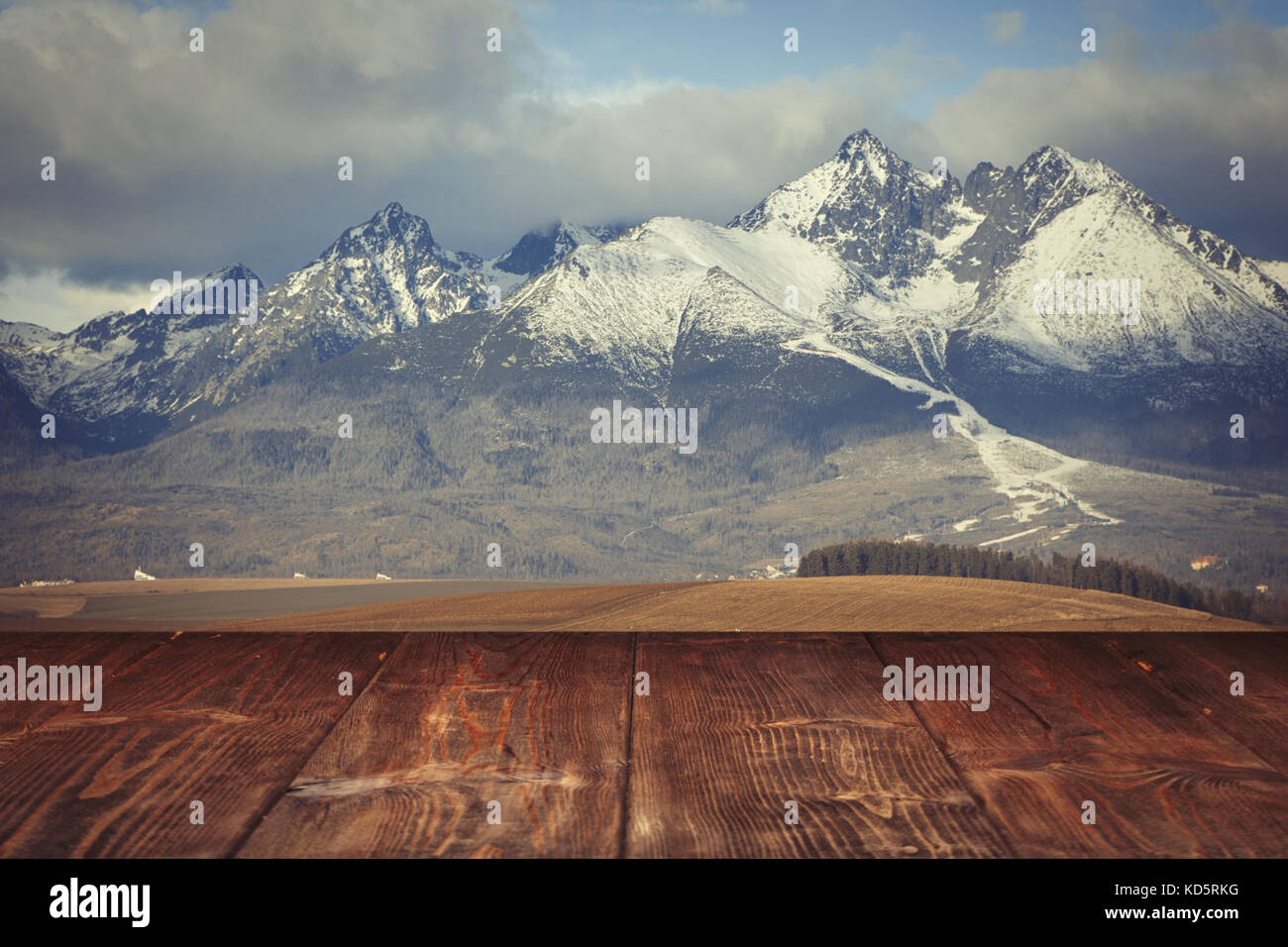 Table on winter mountains background Stock Photo - Alamy