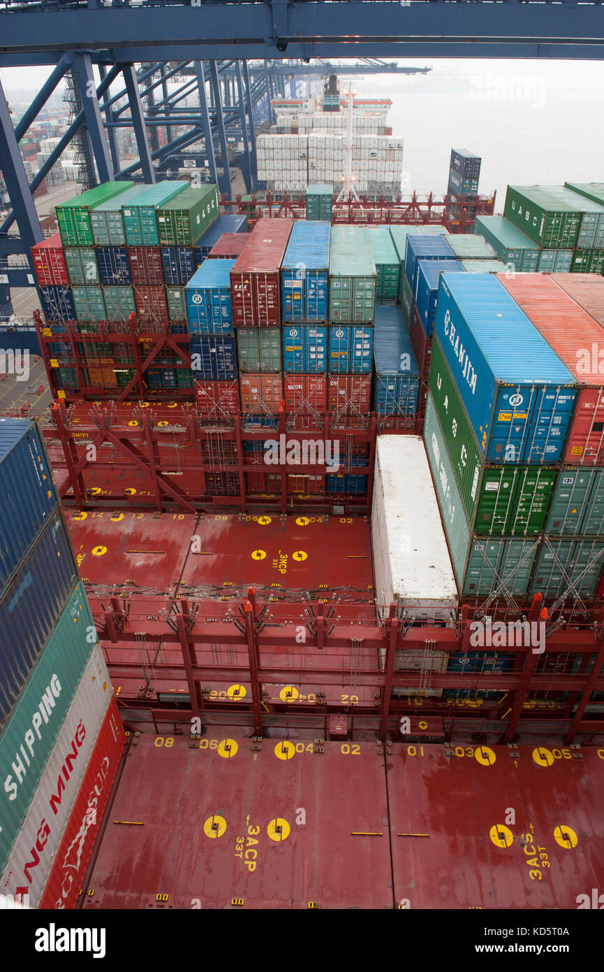 Shipping containers in container port and on-board ship Stock Photo - Alamy
