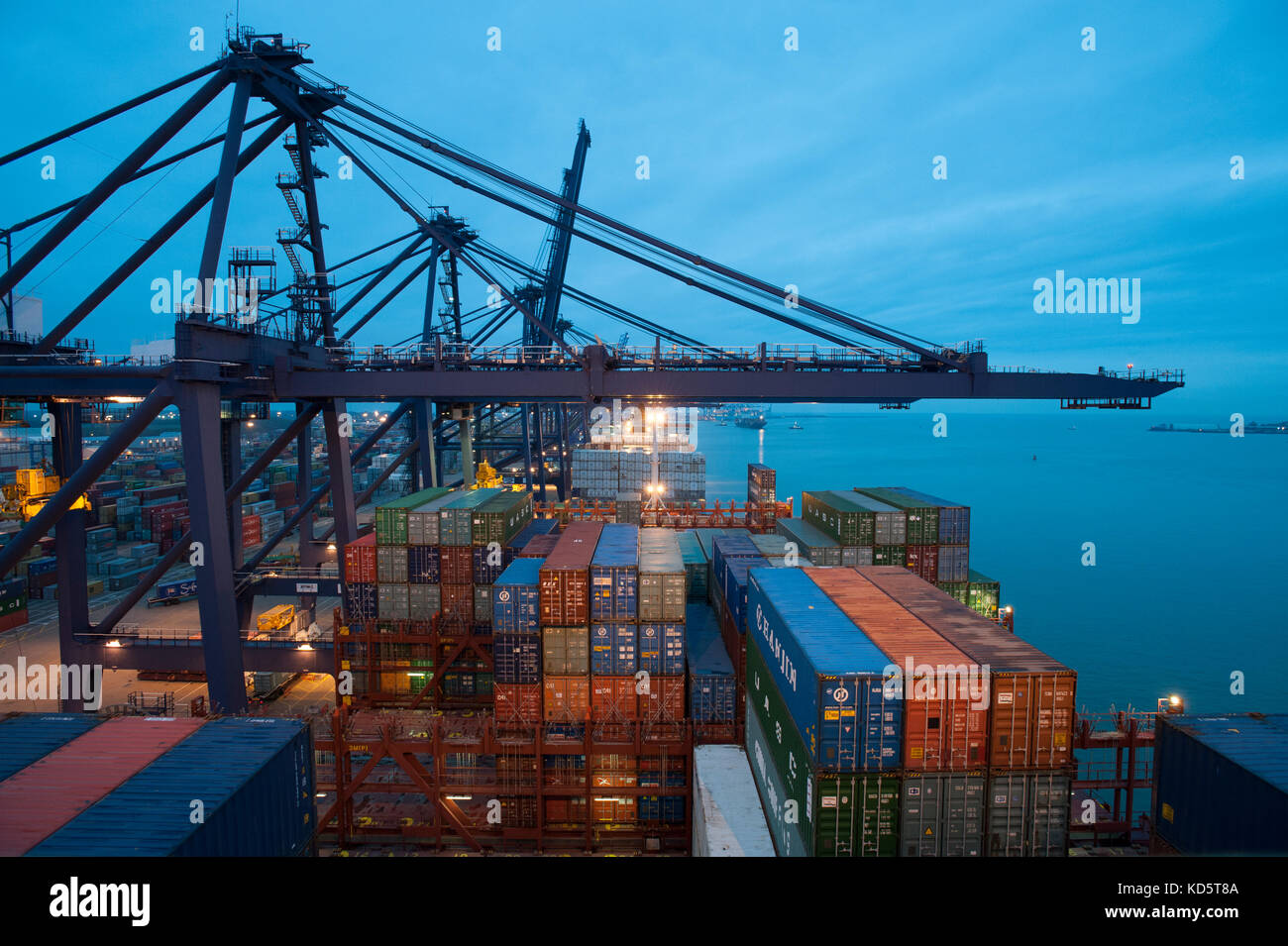 Shipping containers in container port and on-board ship Stock Photo - Alamy