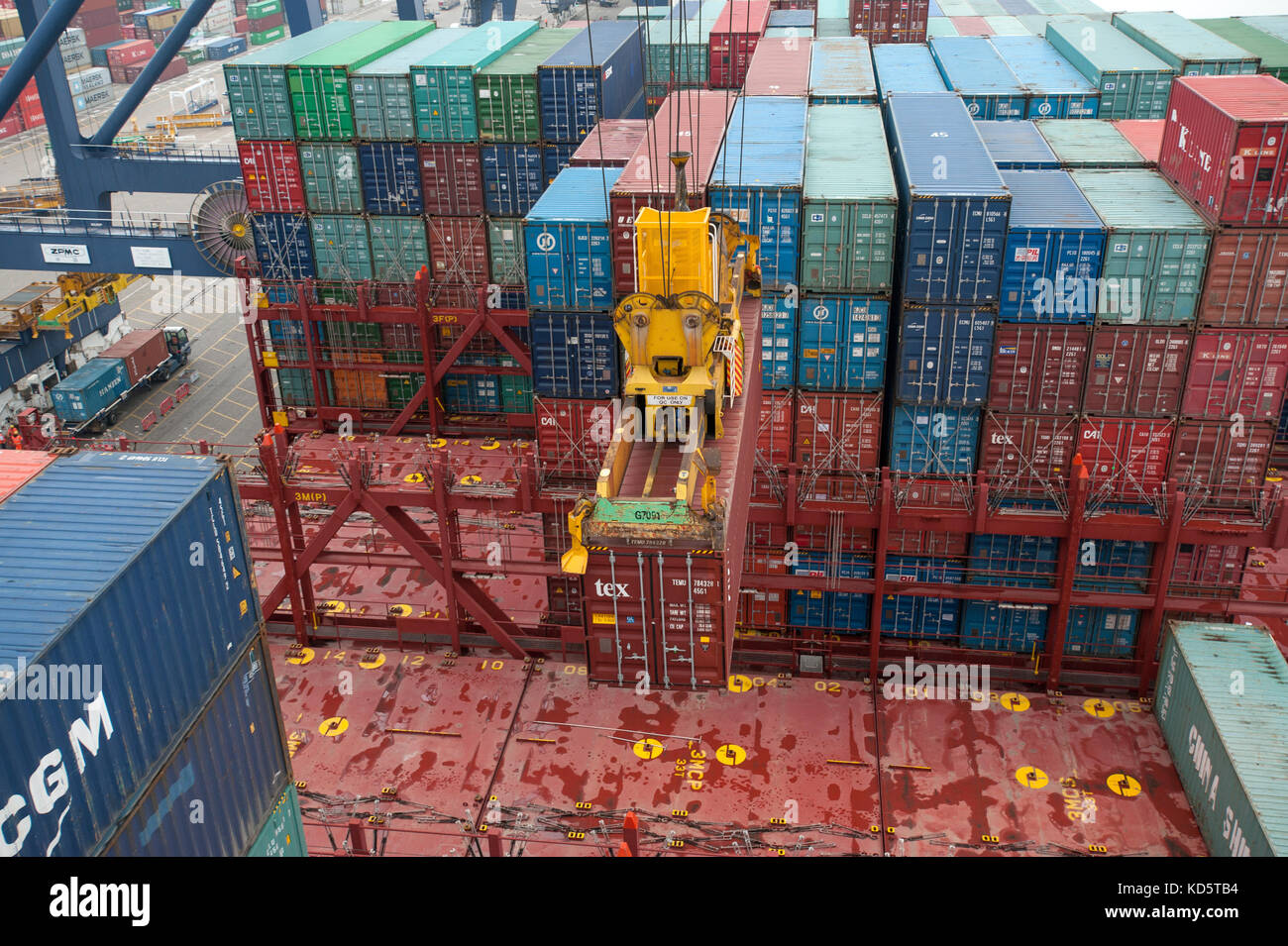 Shipping containers in container port and on-board ship Stock Photo - Alamy
