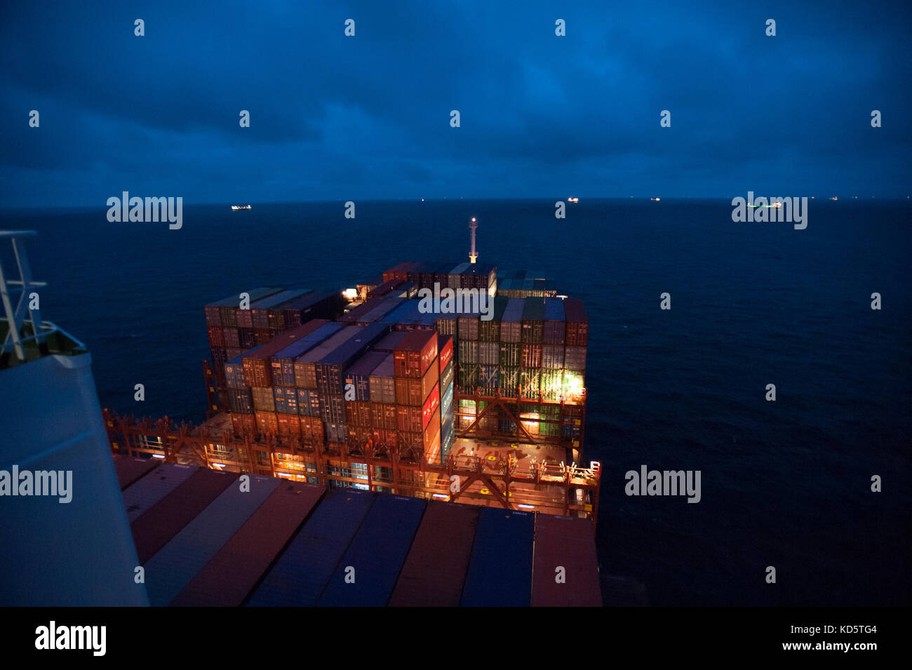 View from the bridge of a container ship approaching anchorage at night ...