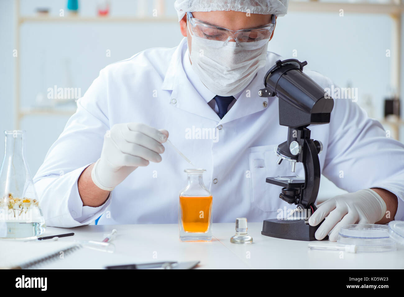 Chemist mixing perfumes in the lab Stock Photo - Alamy