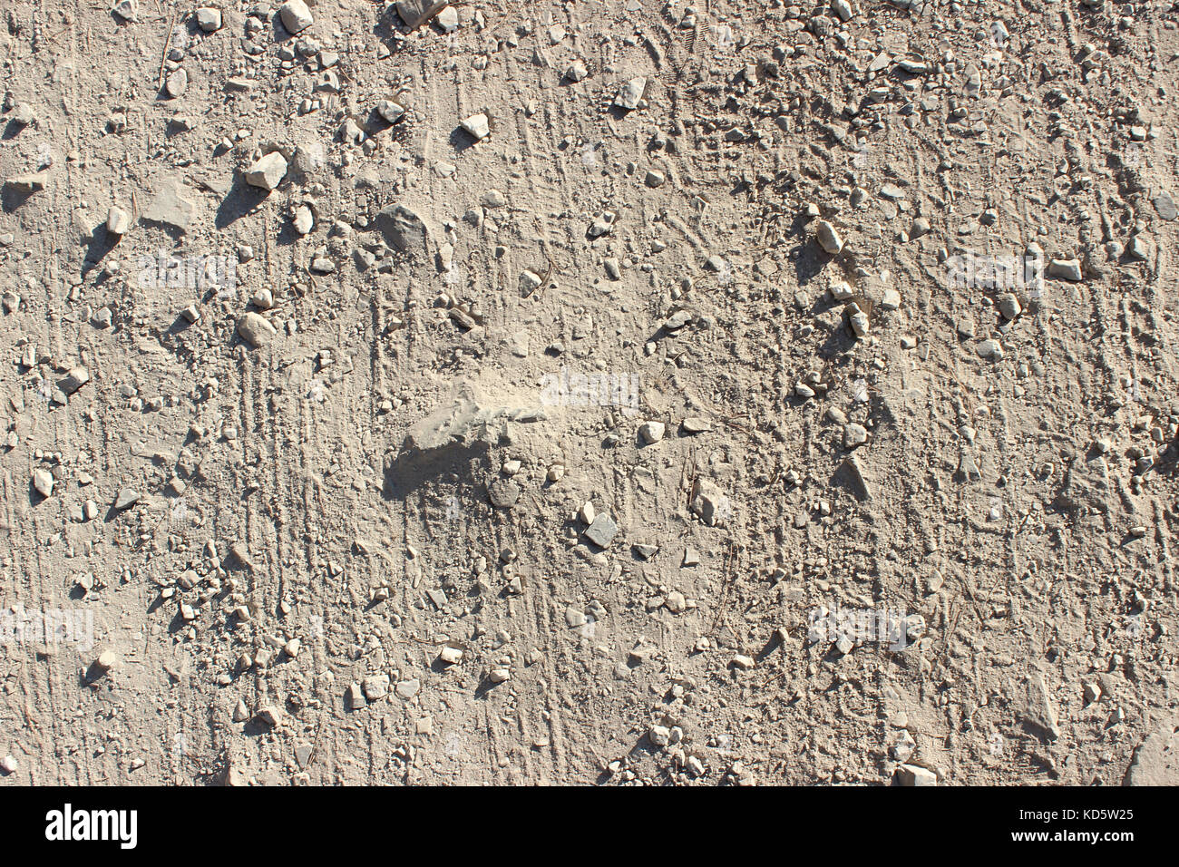 Traces markings and stones on dirt road background Stock Photo - Alamy
