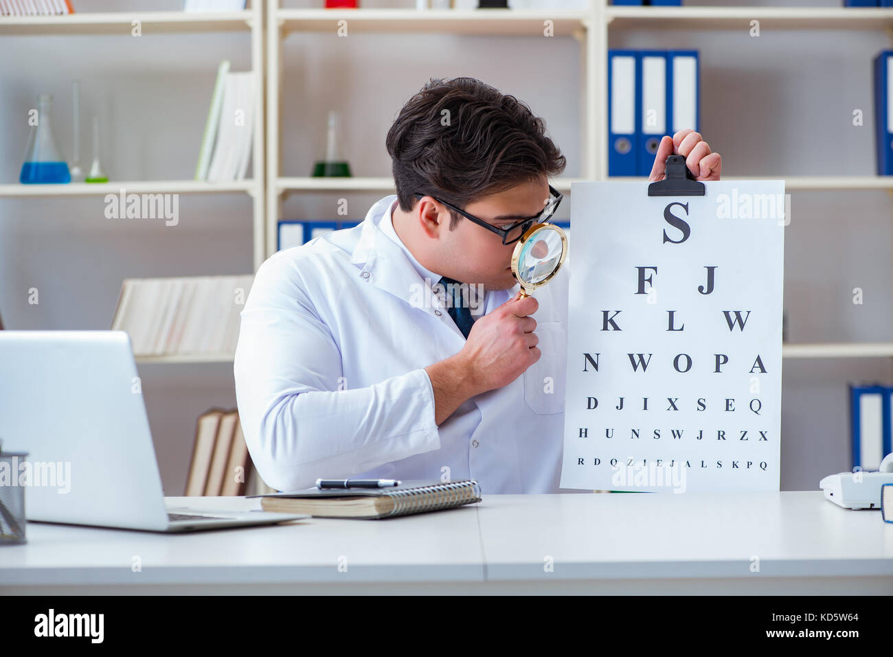 Doctor optician with letter chart conducting an eye test check Stock ...