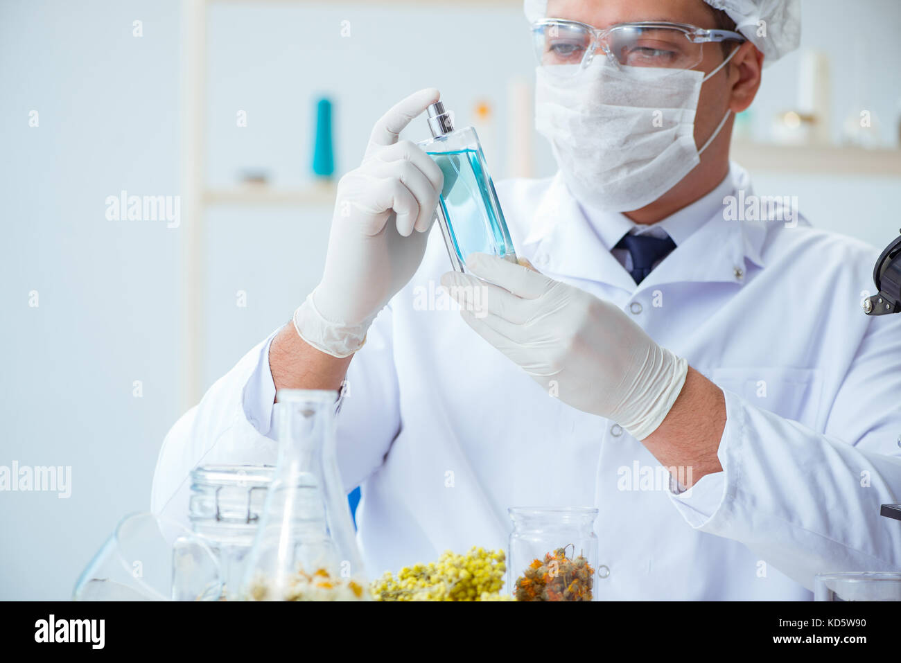 Chemist mixing perfumes in the lab Stock Photo - Alamy