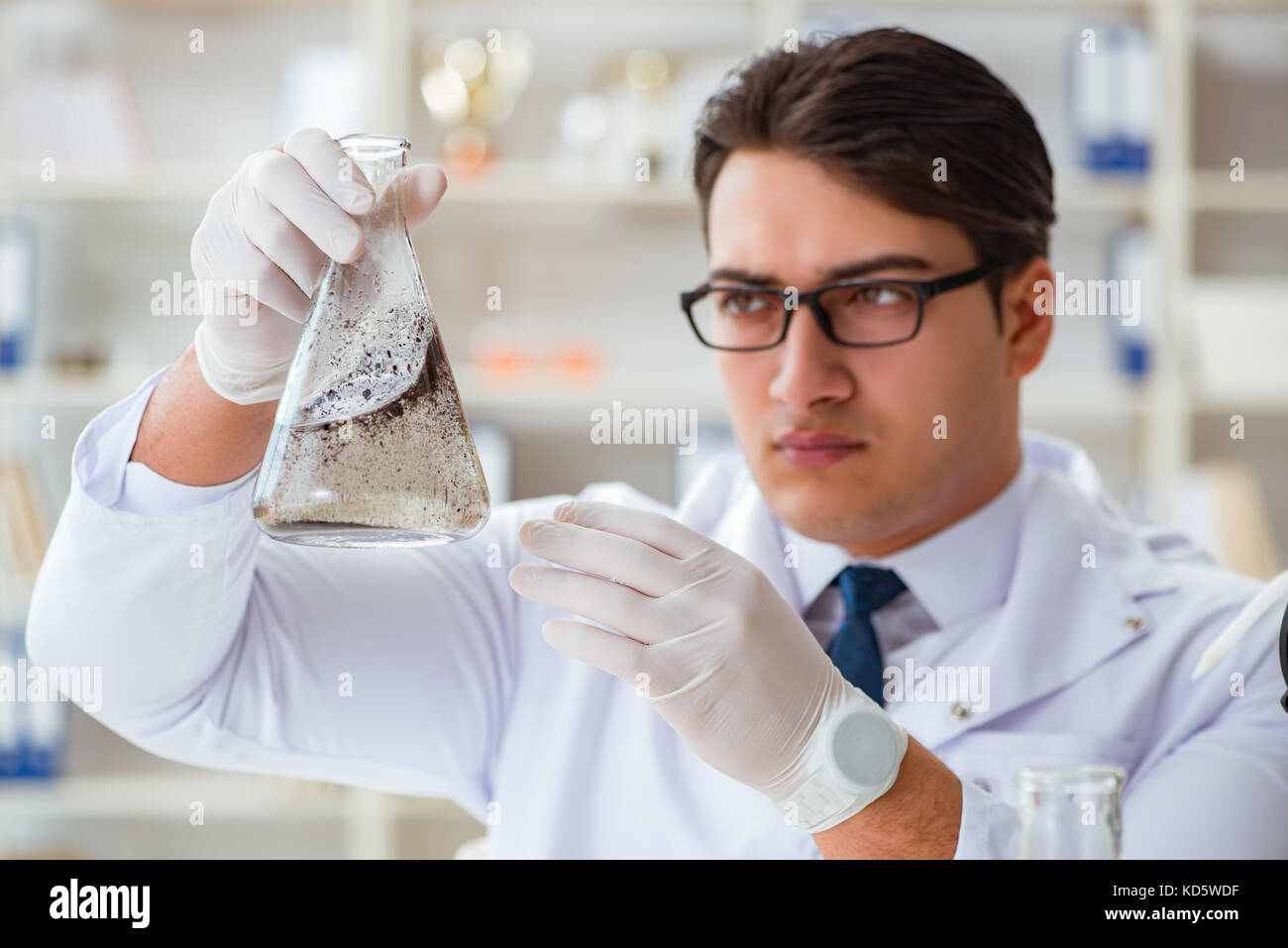 Young researcher scientist doing a water test contamination experiment ...