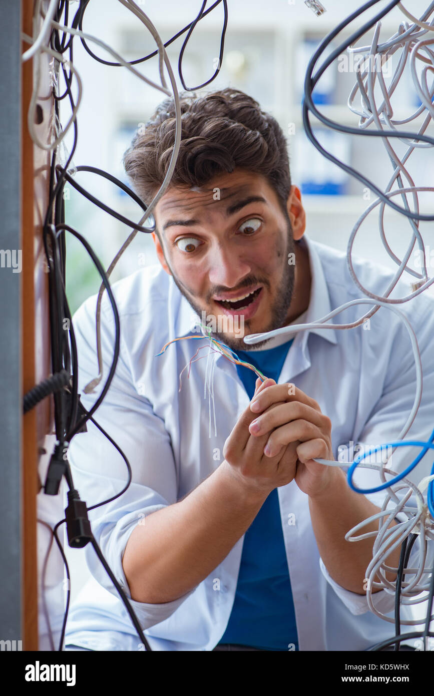 Electrician trying to untangle wires in repair concept Stock Photo - Alamy