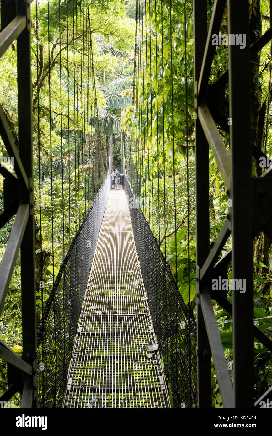 Tourist crossing a hanging bridge in La Fortuna, Costa rica Stock Photo ...