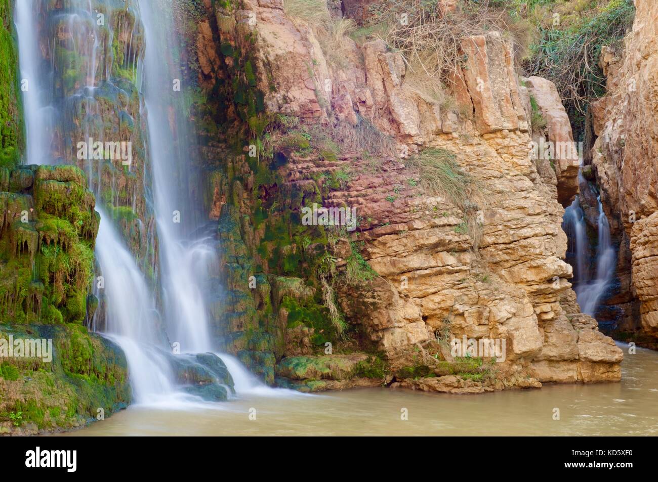 beautiful waterfall falling on a rock wall Stock Photo - Alamy