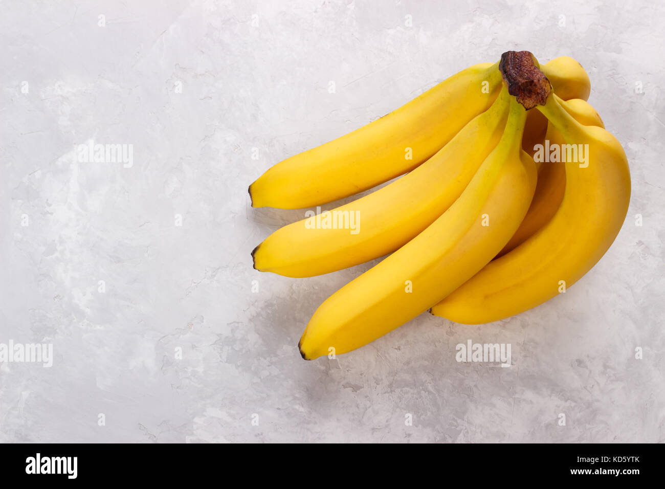 Bunch of ripe bananas on gray stone background. top view with copy ...