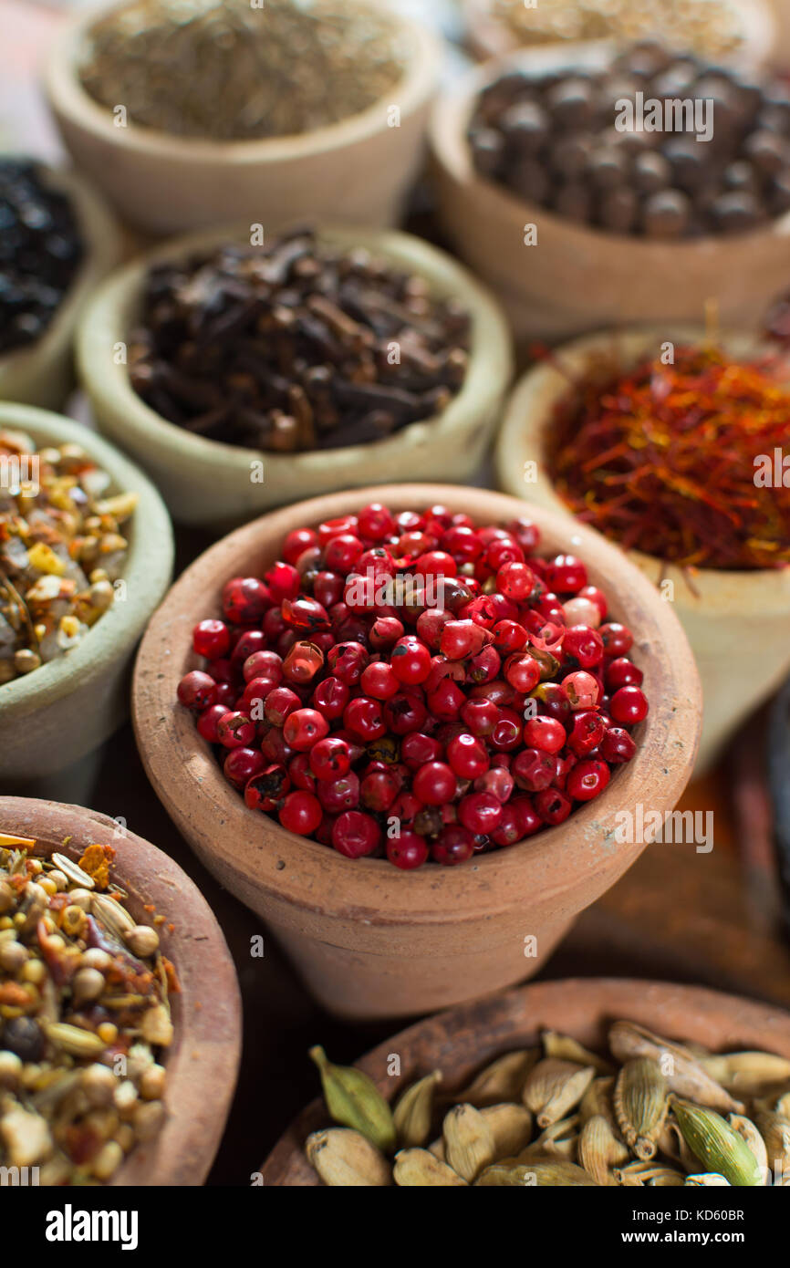 Variety of different spices with focus on pink Peruvian pepper, false ...
