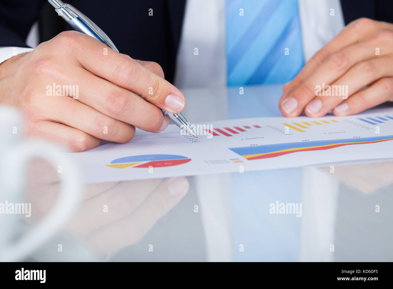 Close-up Of A Businessman Writing On Graph Printed On Paper Stock Photo ...