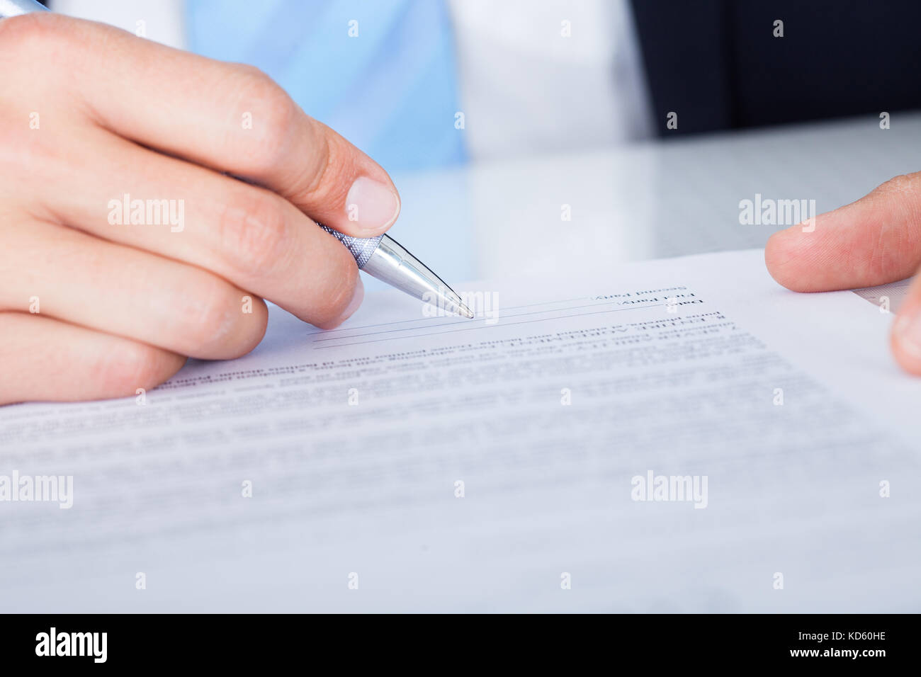 Close-up Of Businessman Signing Contract Paper With Pen Stock Photo - Alamy