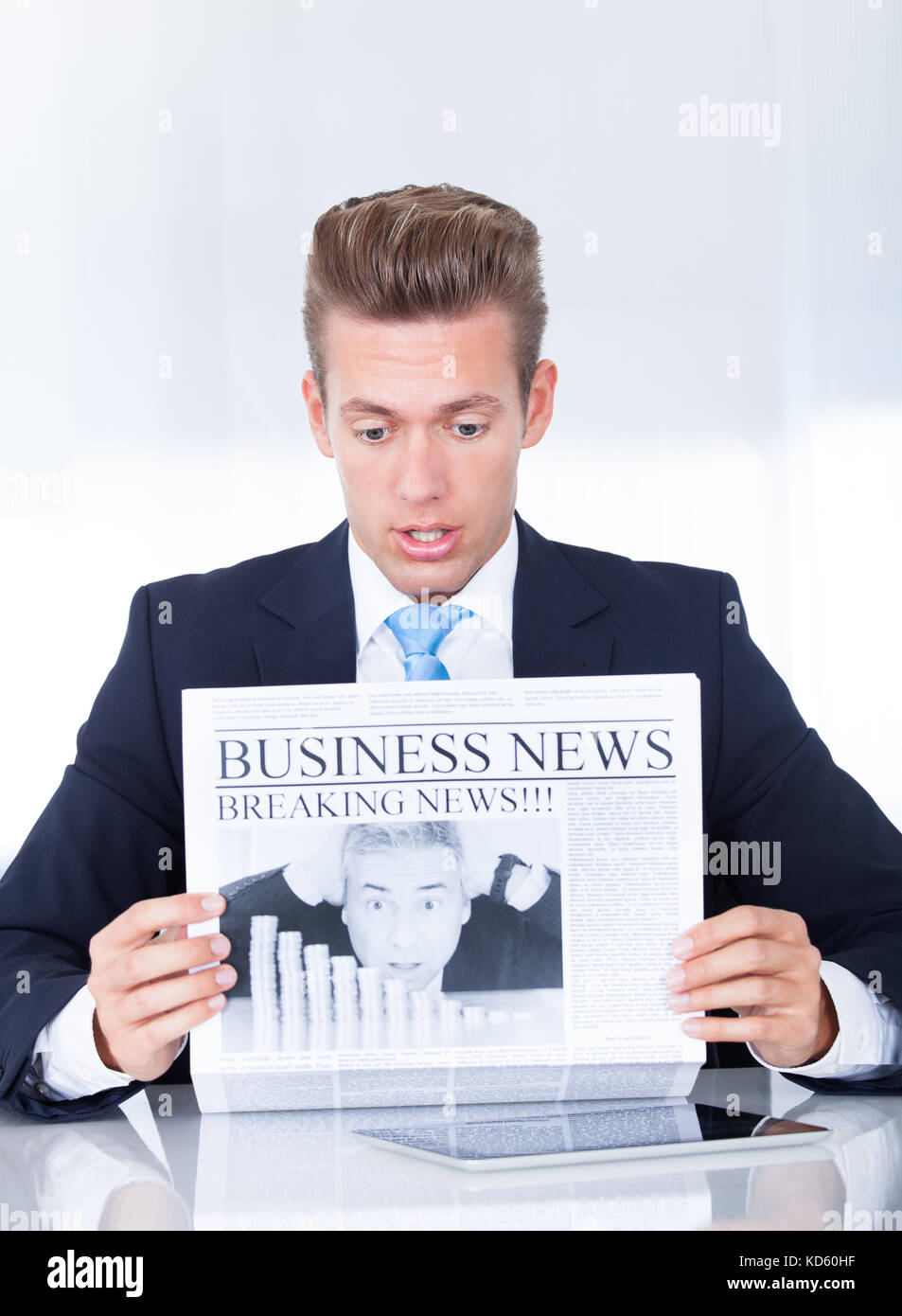 Young Businessman Reading Breaking News On Newspaper Stock Photo - Alamy
