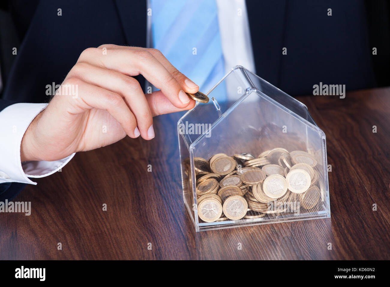 Close-up Of Businessman Inserting Euro Coin In Money Box Stock Photo ...