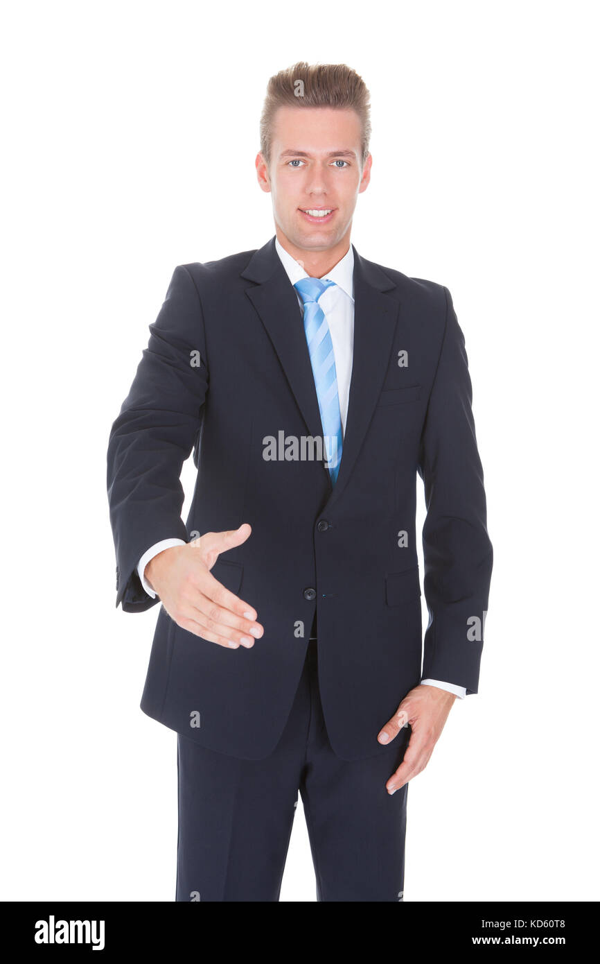 Happy Young Businessman Extending Hand To Shake Stock Photo - Alamy